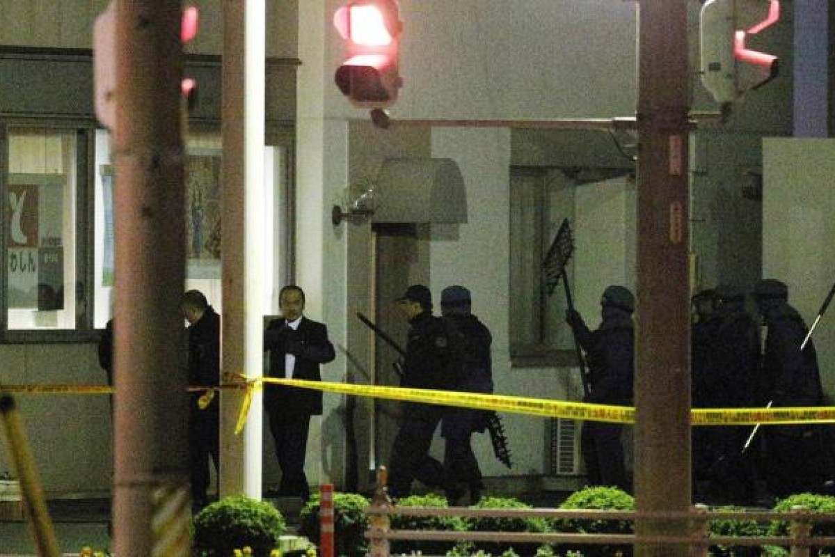 Hostages freed from Japan bank after police find captor sleeping ...