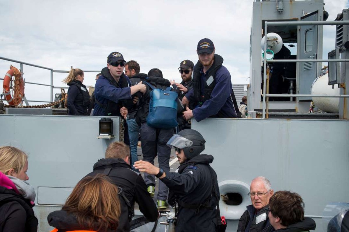 Tourists escape quake town as first US warship to visit New Zealand in ...