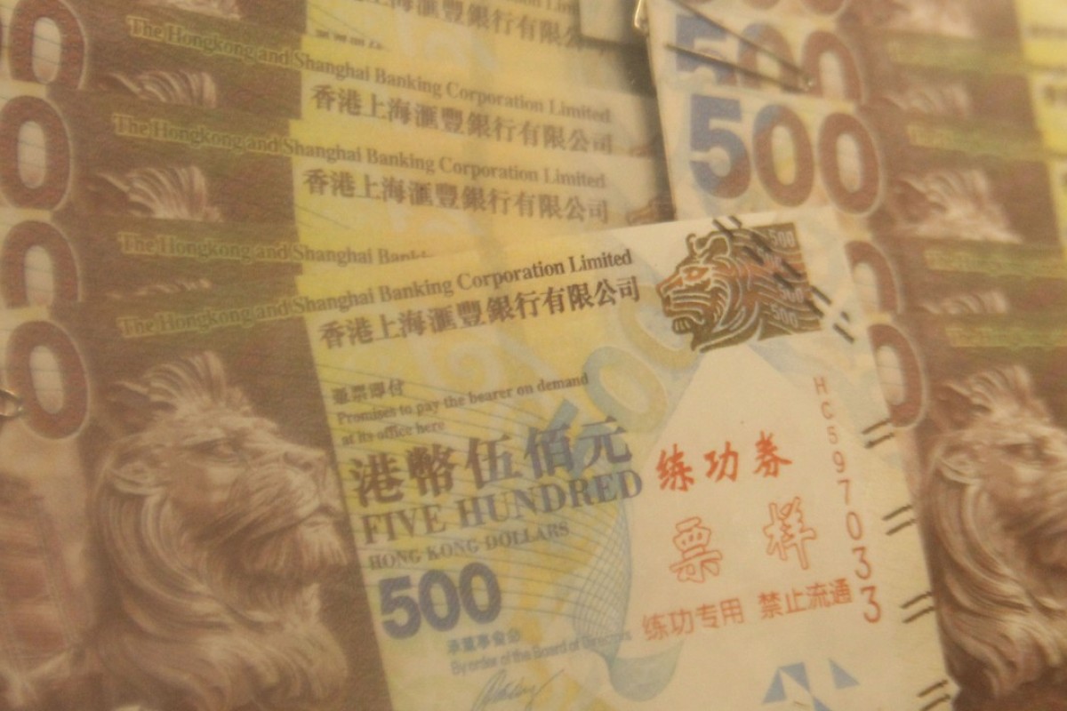 Hong Kong taxi driver arrested for scamming passengers with fake ...