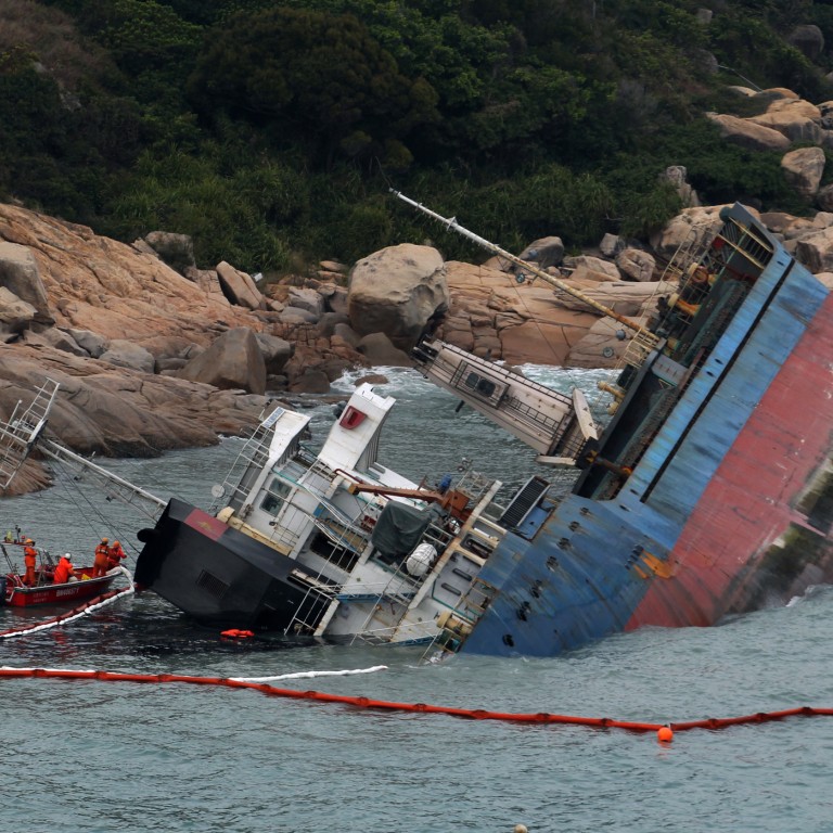 Stricken cargo ship overturns in Hong Kong as frightened crew abandon ...