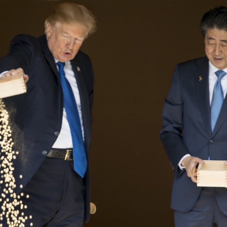 Fishy business: Trump and Abe dump fish food into precious koi carp ...