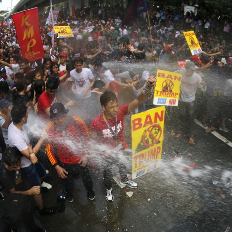 Riot police use water cannon to repel anti-Trump protesters in Manila ...
