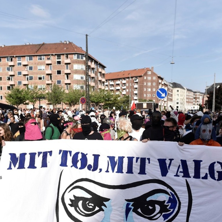 Hundreds protest in Denmark as ban on face veils in public takes effect ...
