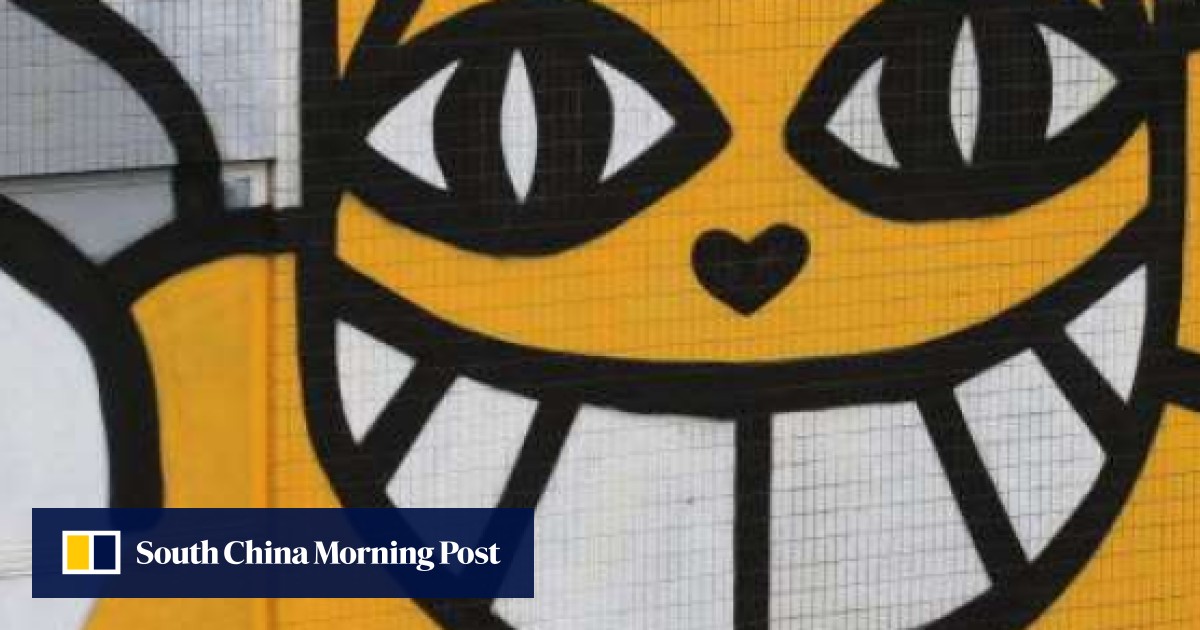 Graffiti artist M. Chat completes giant mural of grinning yellow cat on ...